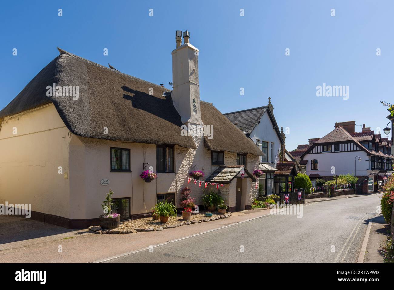 A thatched cottage on the High Street in the village of Porlock, Exmoor ...