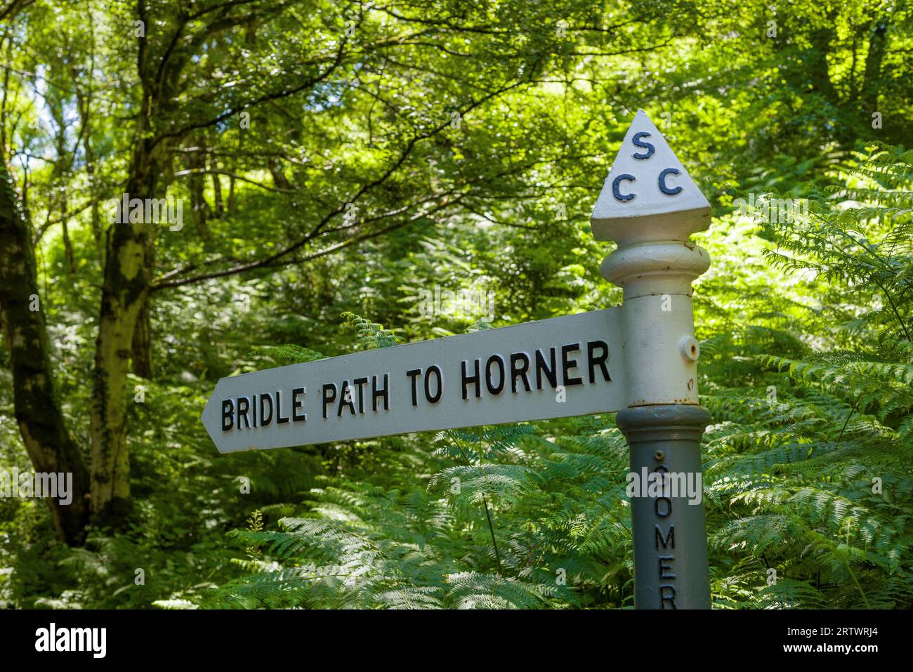 A traditional iron finger signpost indicating the start of a bridlepath ...