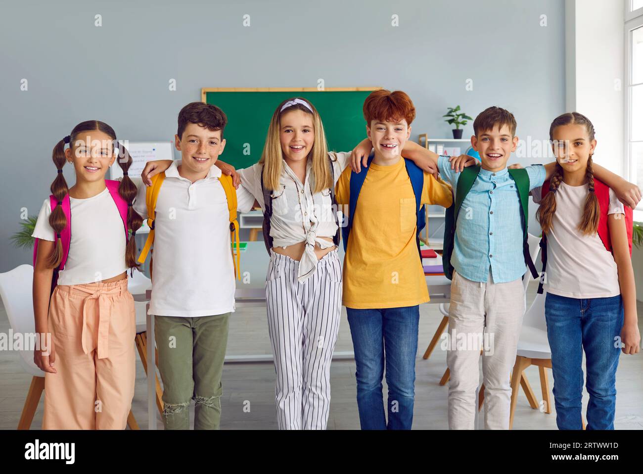 Group of elementary school students standing together in row and ...