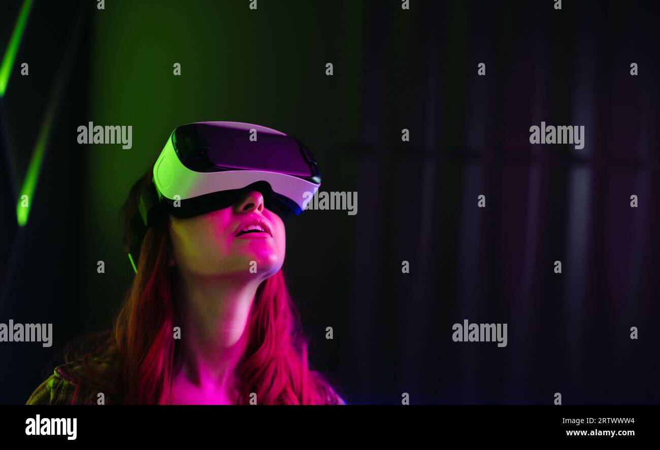 Young woman looking at the immersive digital environment around her ...