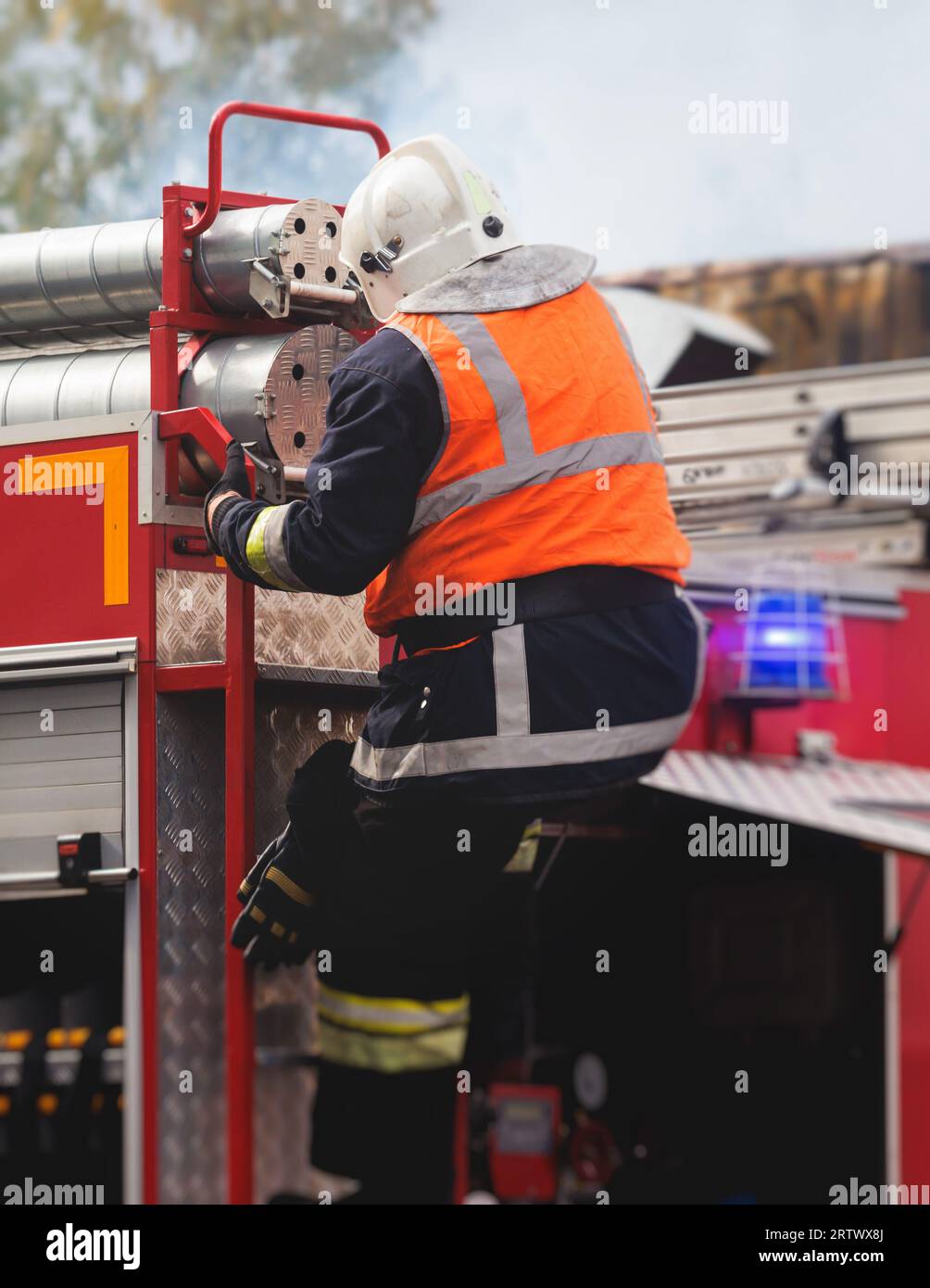 Group of fire men in protective uniform during fire fighting operation ...