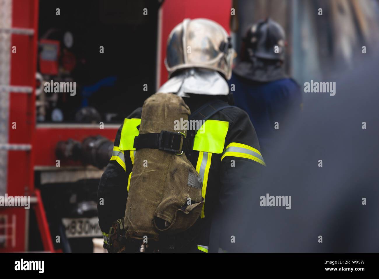 Group of fire men in protective uniform during fire fighting operation ...