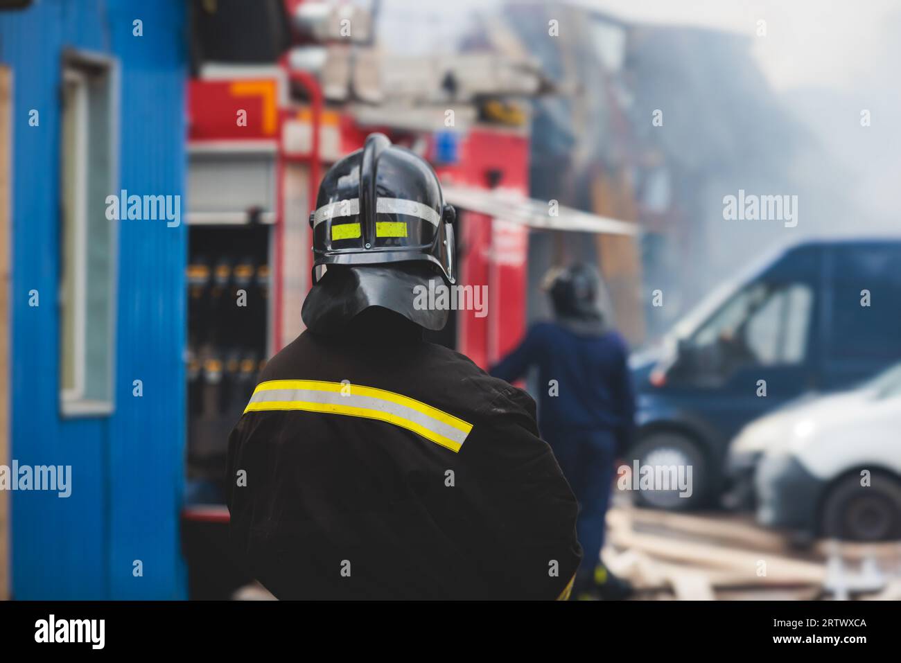 Group of fire men in protective uniform during fire fighting operation ...