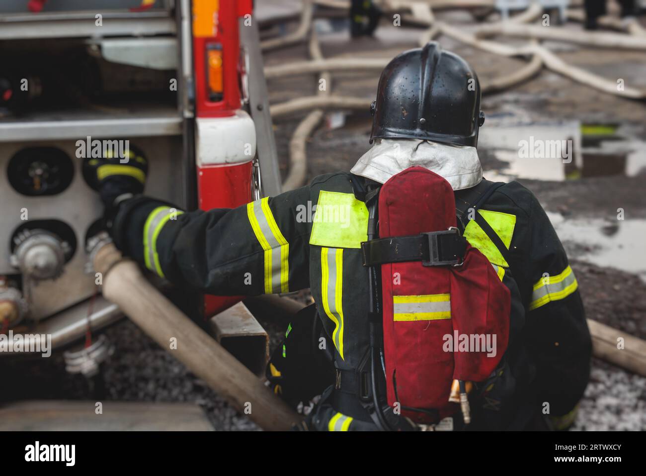Group of fire men in protective uniform during fire fighting operation ...
