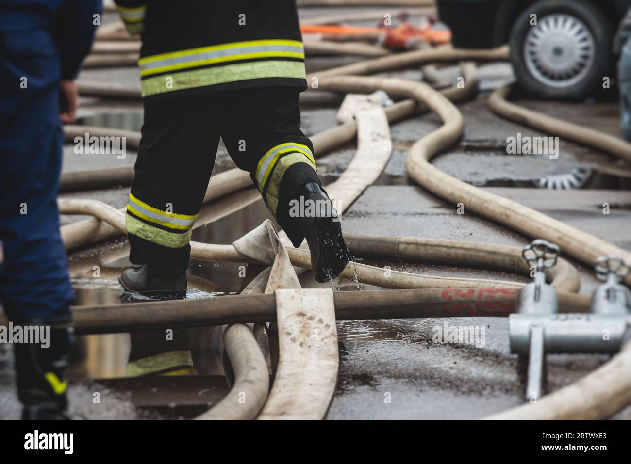 Group of fire men in protective uniform during fire fighting operation ...