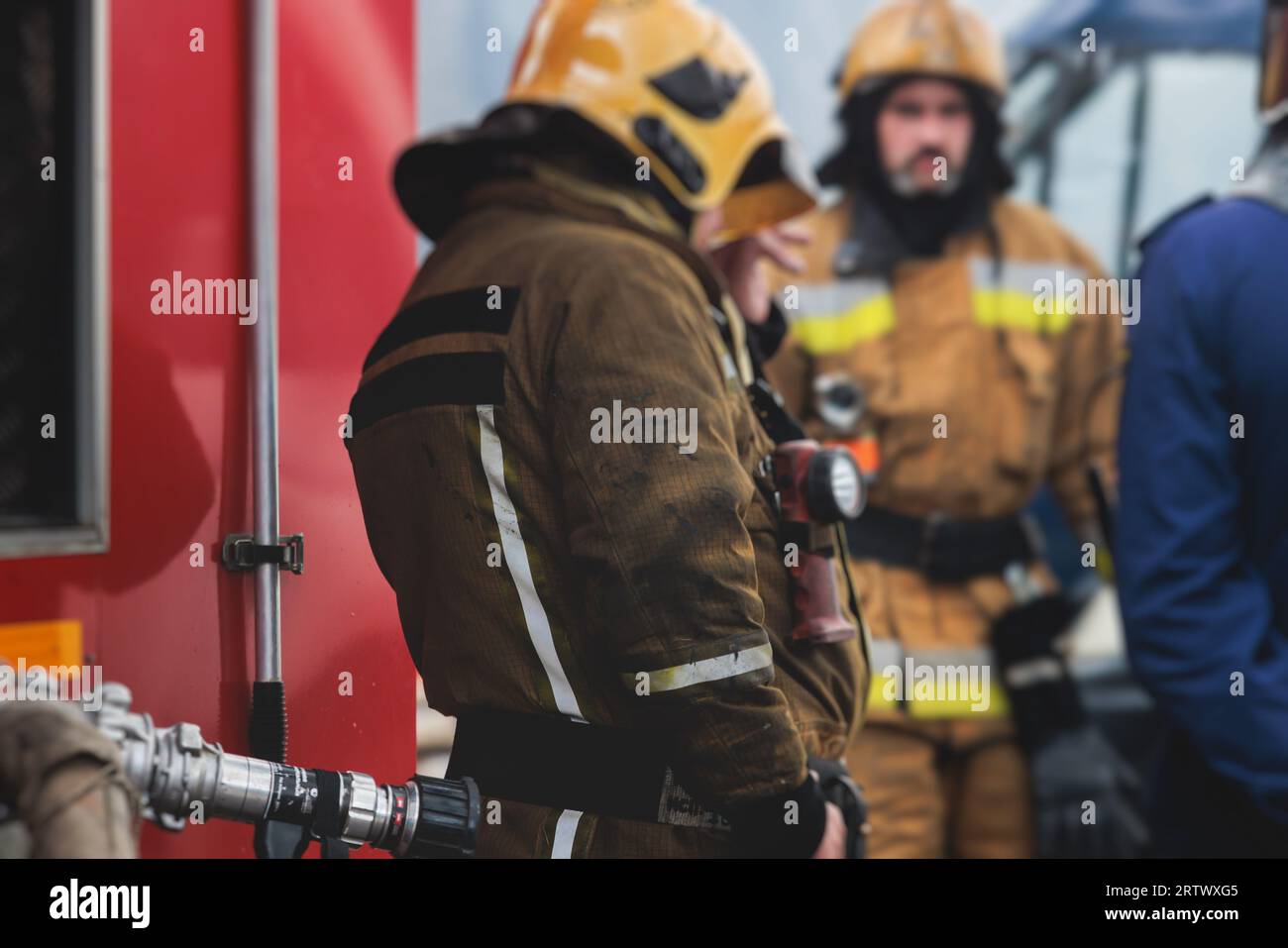 Group of fire men in protective uniform during fire fighting operation ...