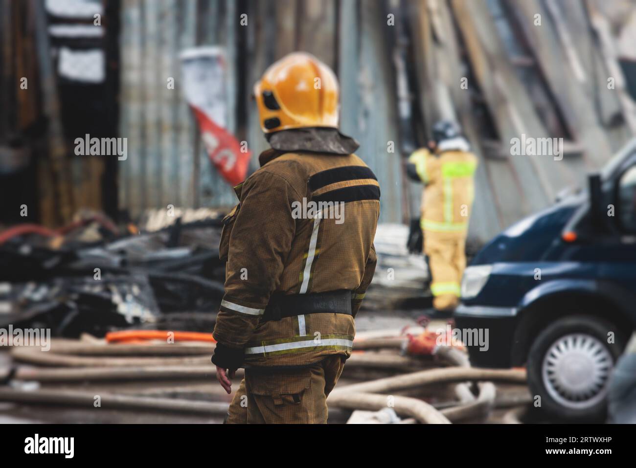 Group of fire men in protective uniform during fire fighting operation ...