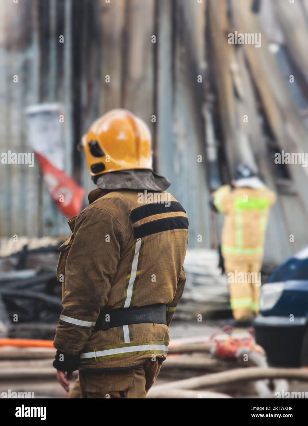 Group of fire men in protective uniform during fire fighting operation ...