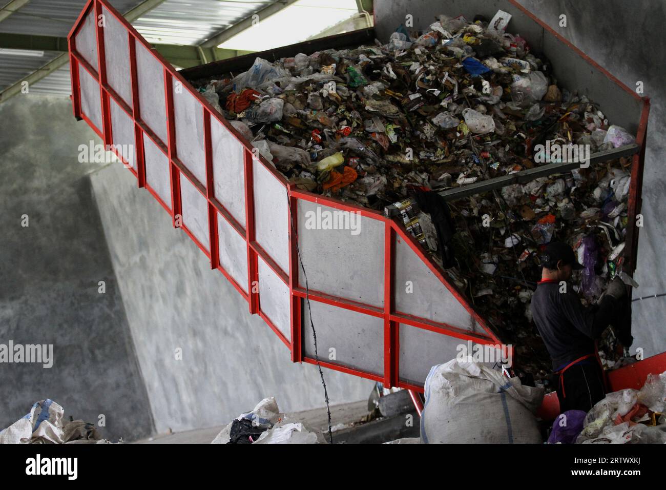 Sleman, Yogyakarta, Indonesia. 15th Sep, 2023. A worker sort waste at ...