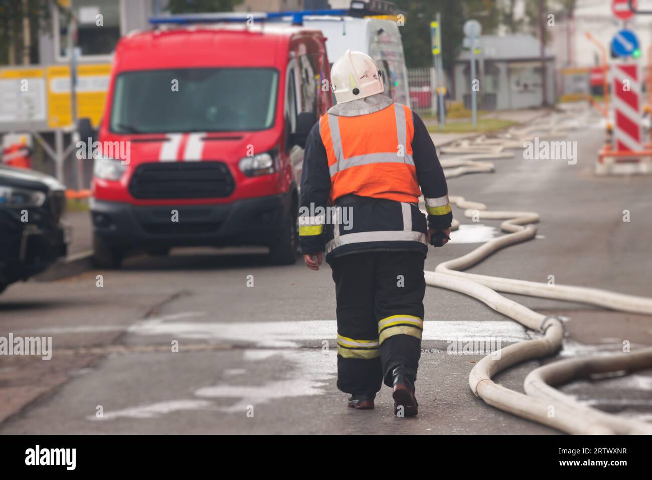Group of fire men in protective uniform during fire fighting operation ...