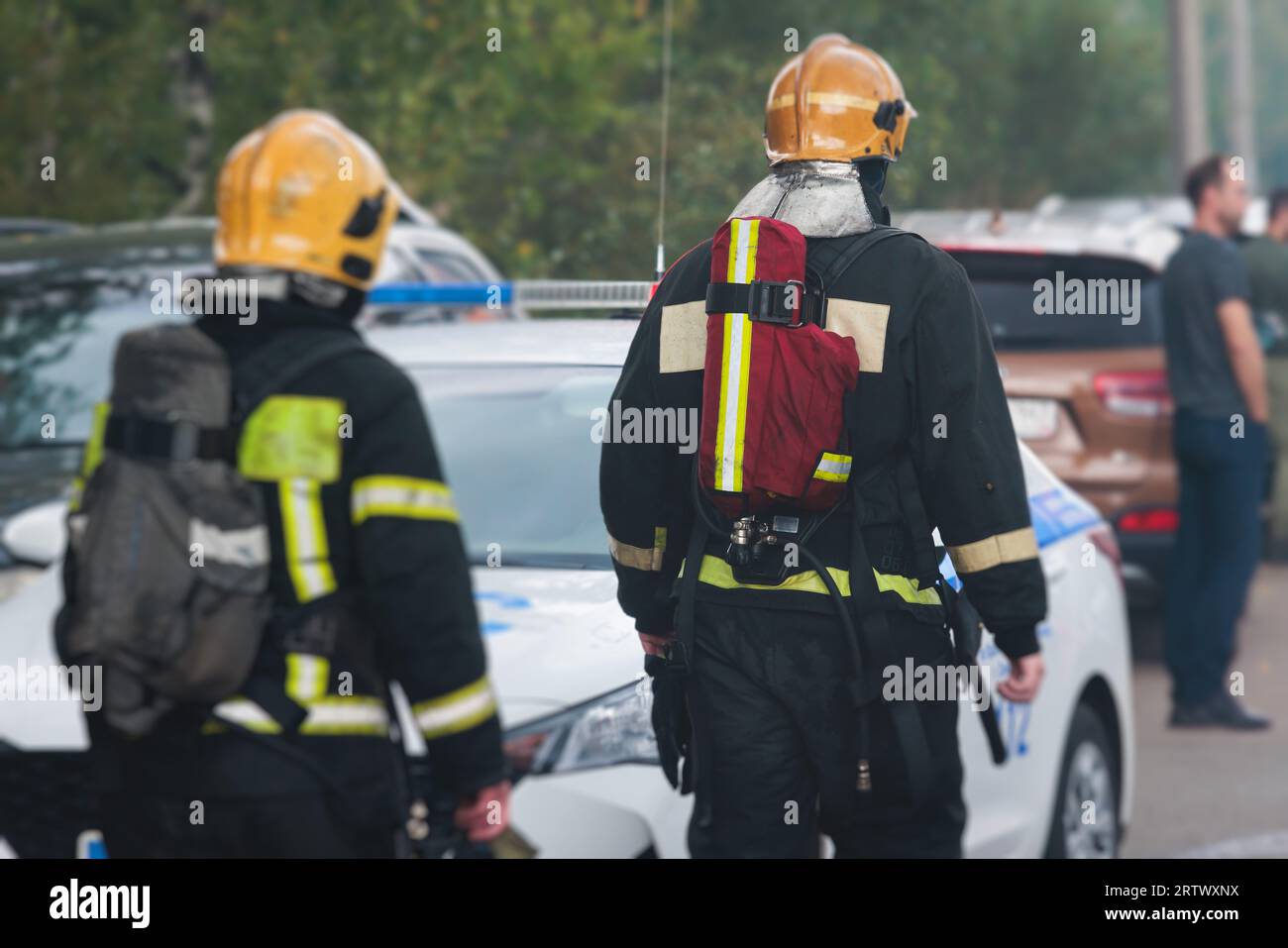 Group of fire men in protective uniform during fire fighting operation ...