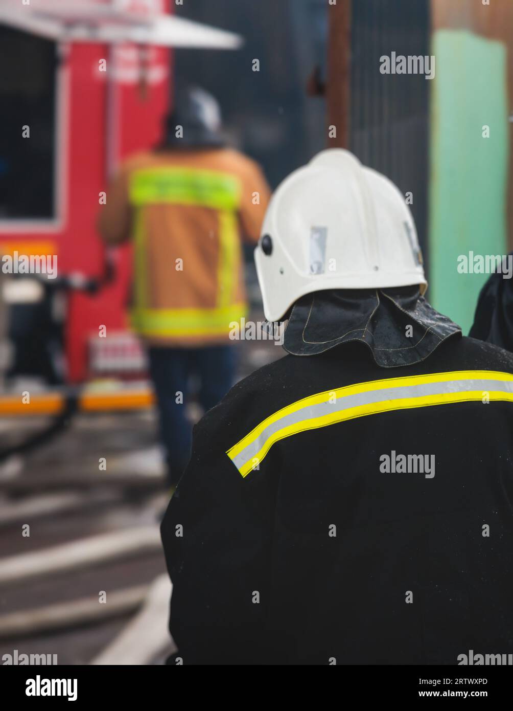Group of fire men in protective uniform during fire fighting operation ...