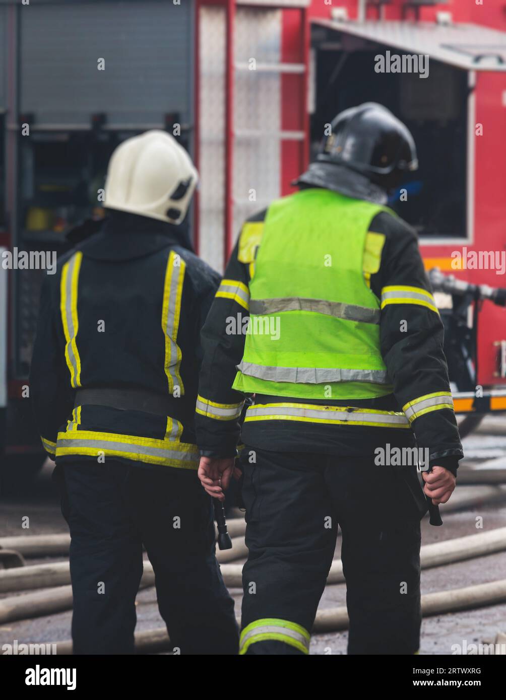 Group of fire men in protective uniform during fire fighting operation ...