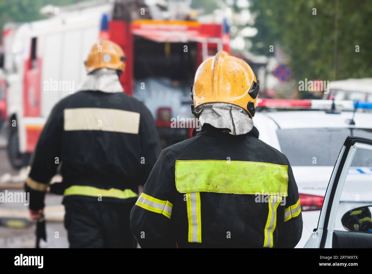 Group of fire men in protective uniform during fire fighting operation ...