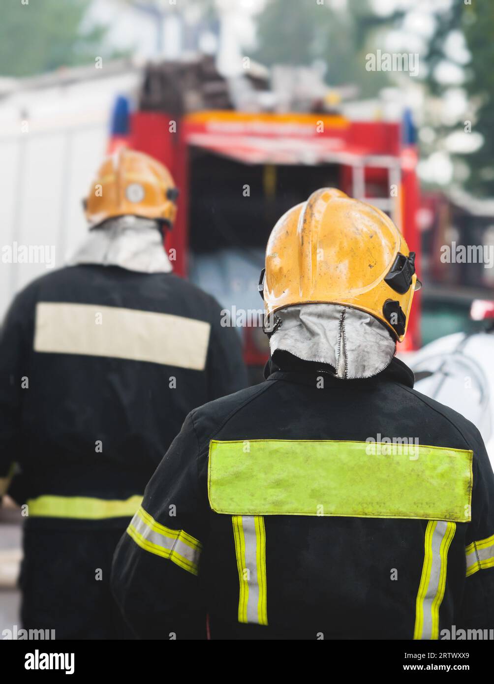Group of fire men in protective uniform during fire fighting operation ...