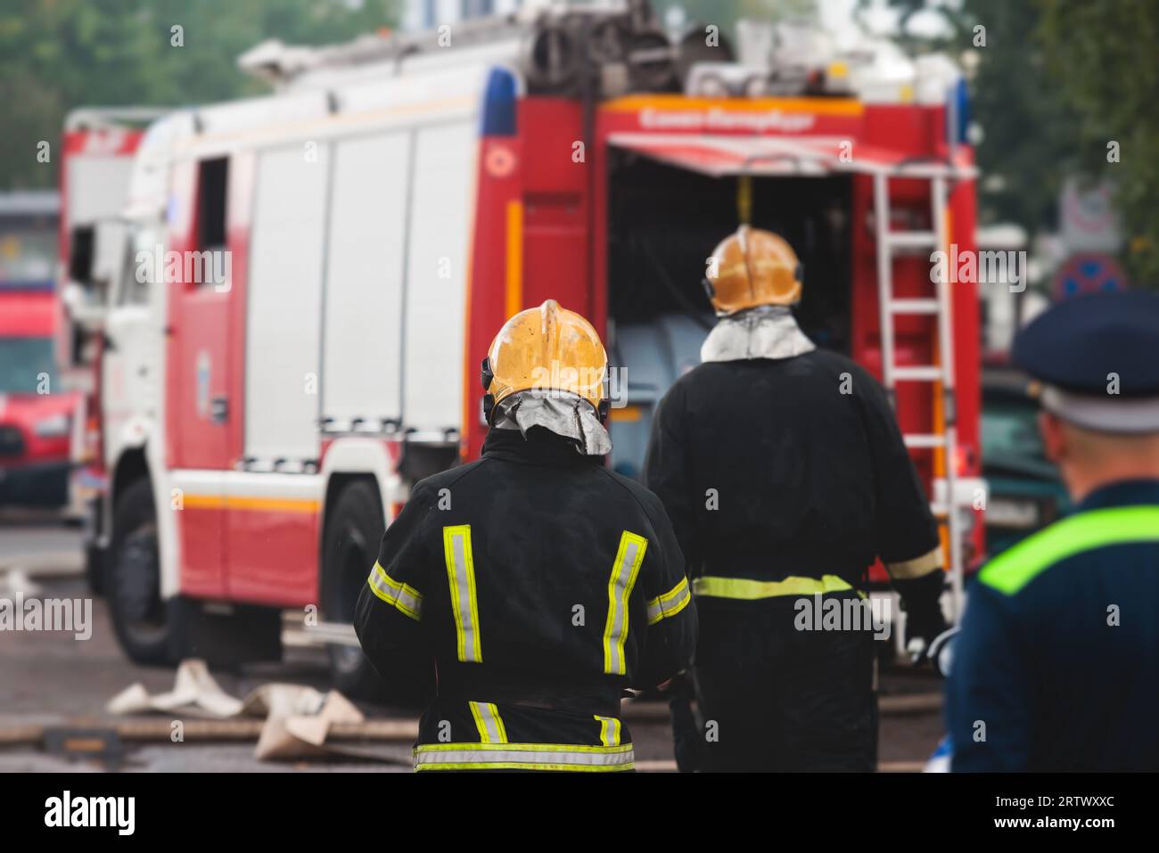 Group of fire men in protective uniform during fire fighting operation ...