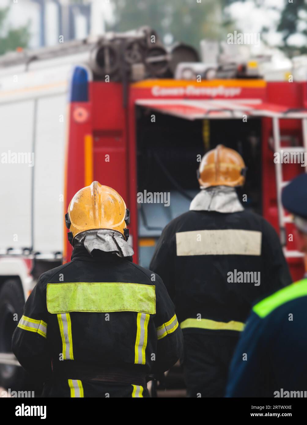 Group of fire men in protective uniform during fire fighting operation ...