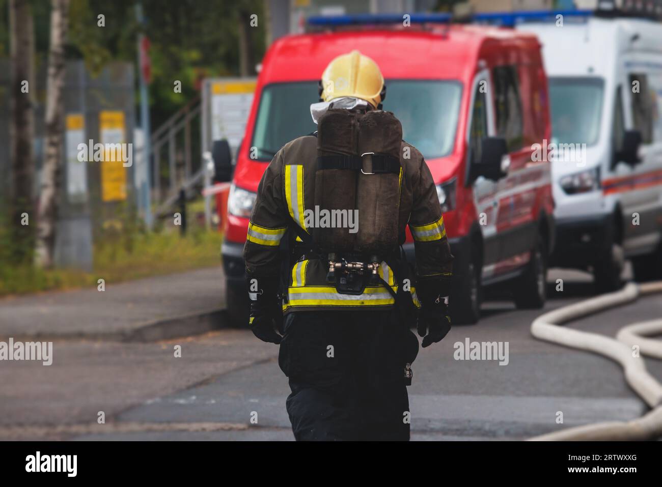 Group of fire men in protective uniform during fire fighting operation ...