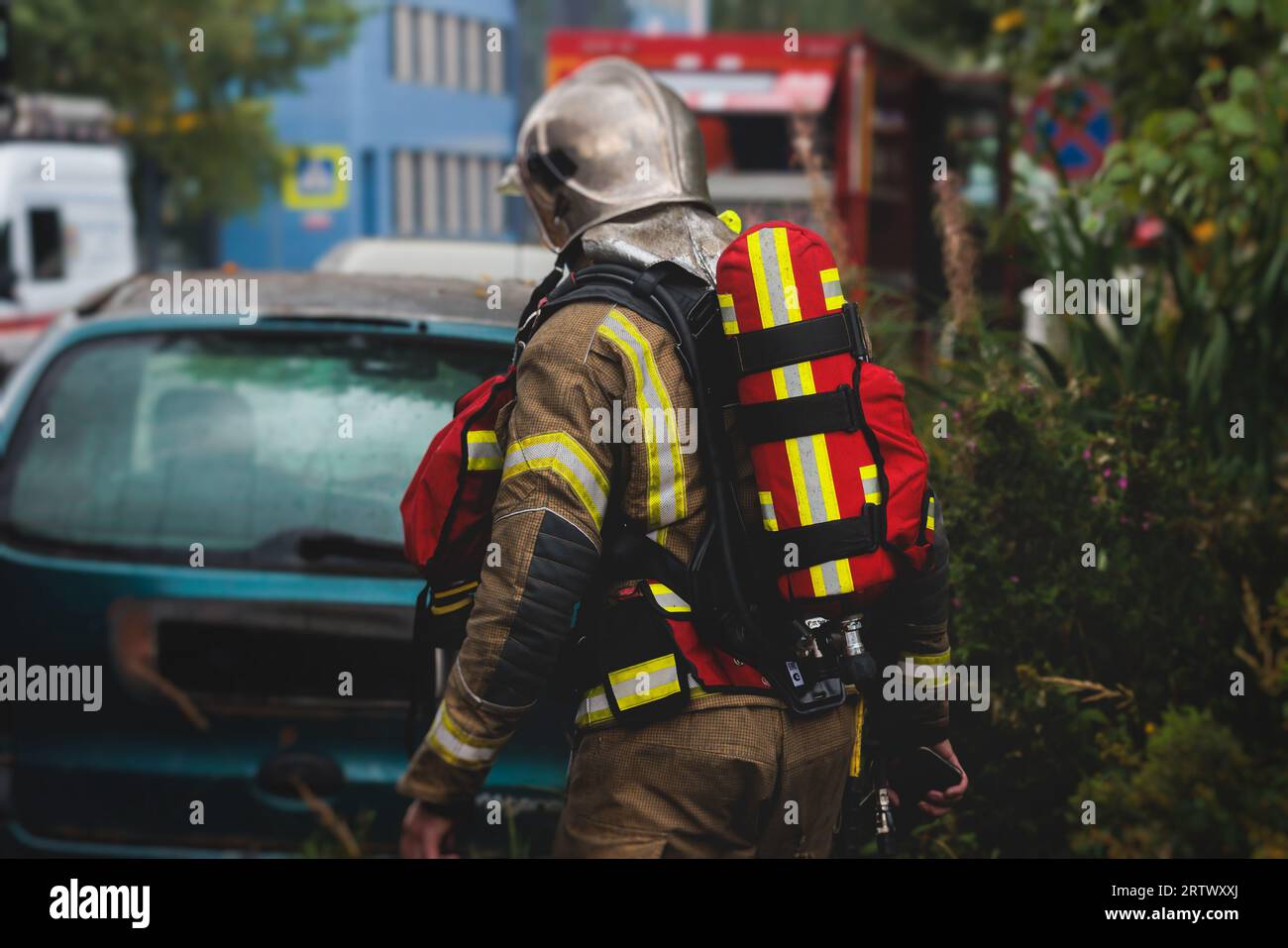 Group of fire men in protective uniform during fire fighting operation ...