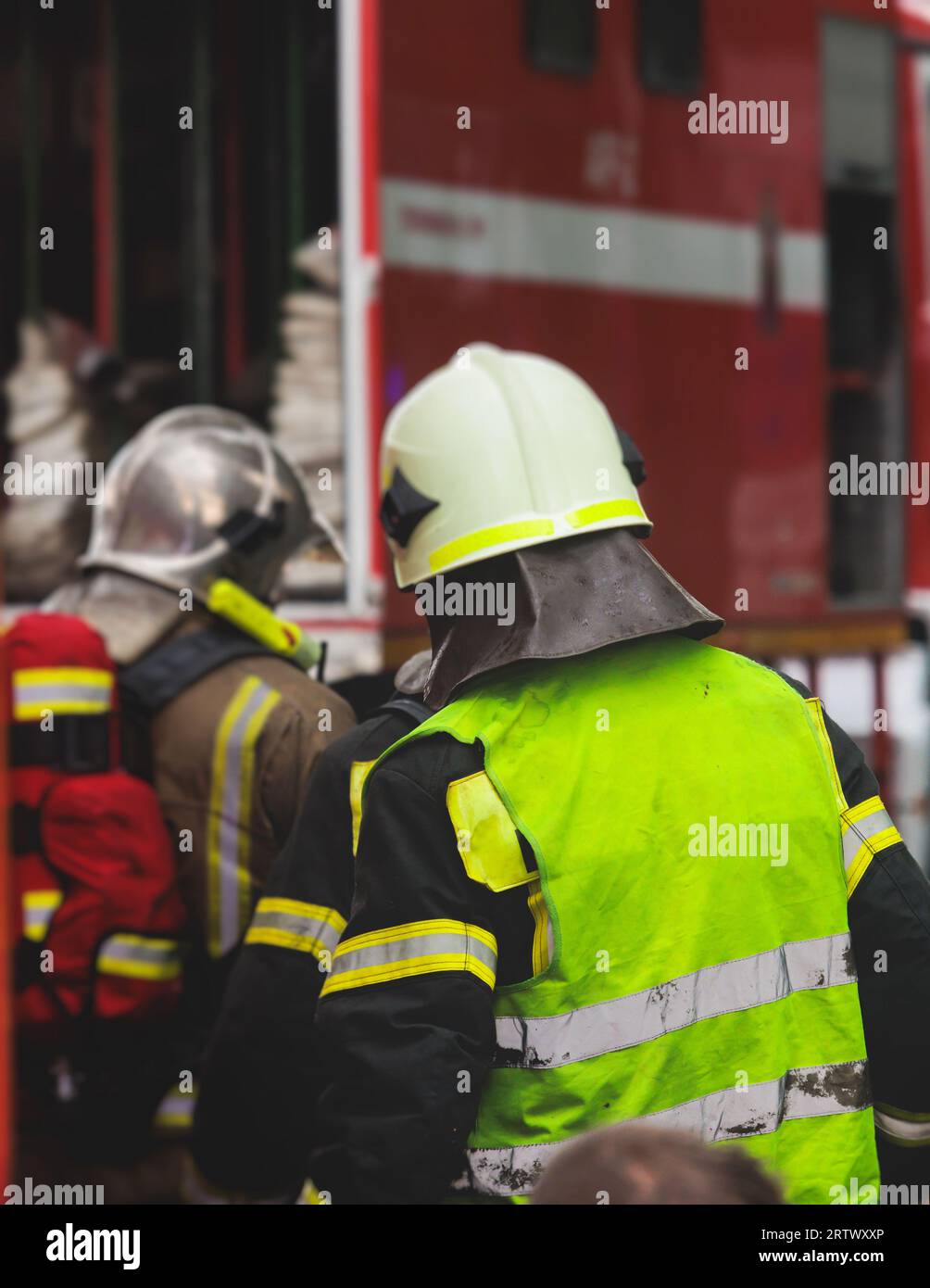 Group of fire men in protective uniform during fire fighting operation ...