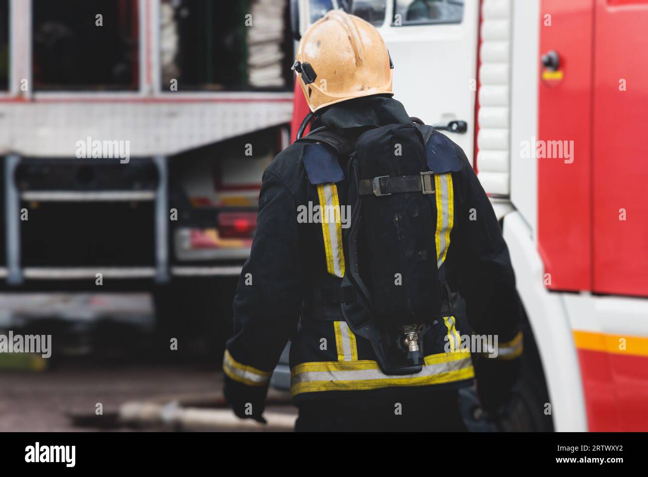 Group of fire men in protective uniform during fire fighting operation ...