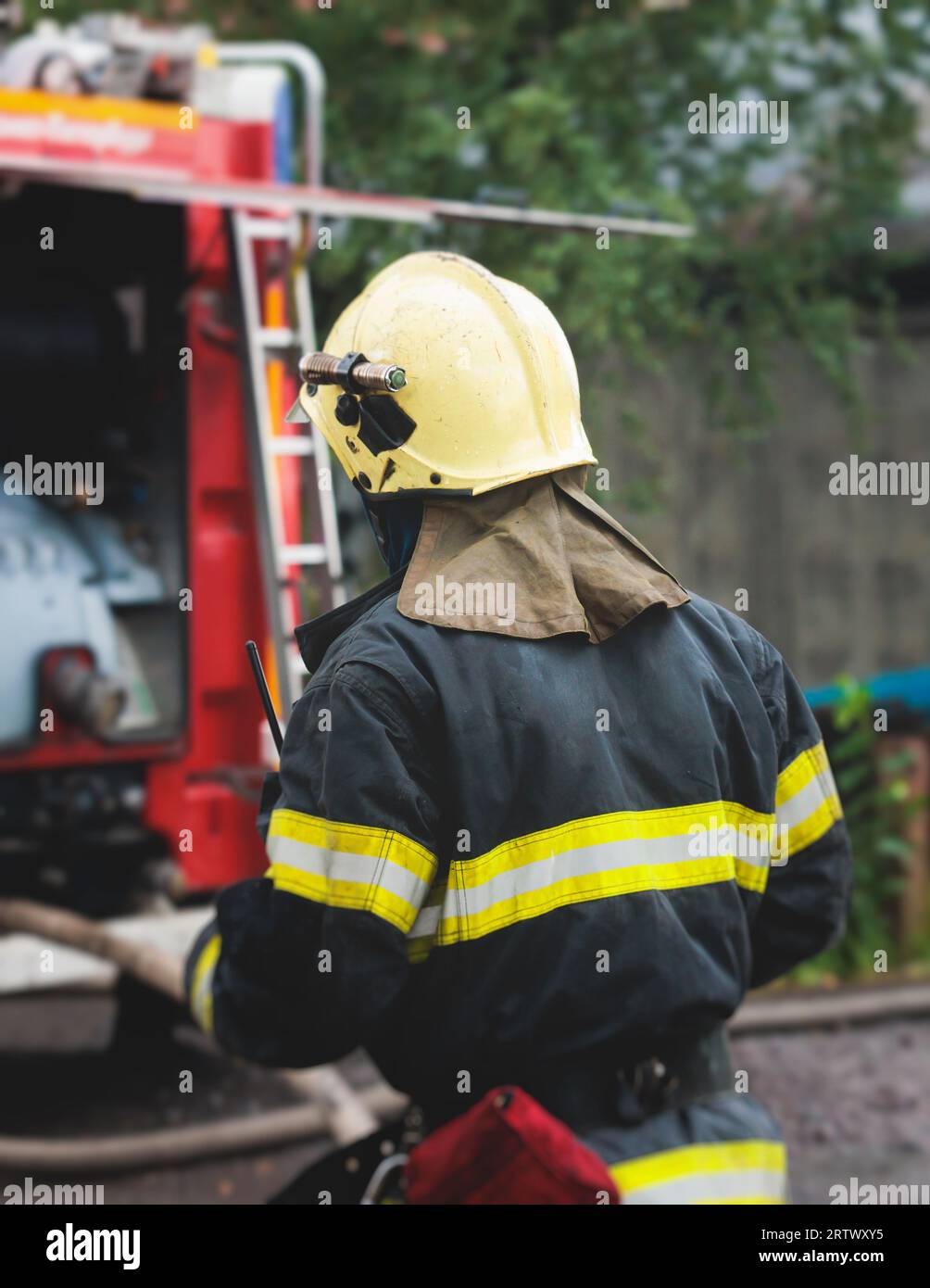 Group of fire men in protective uniform during fire fighting operation ...