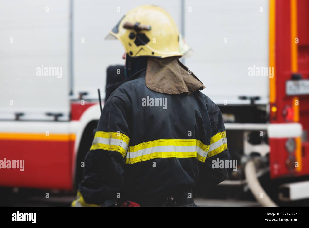 Group of fire men in protective uniform during fire fighting operation ...