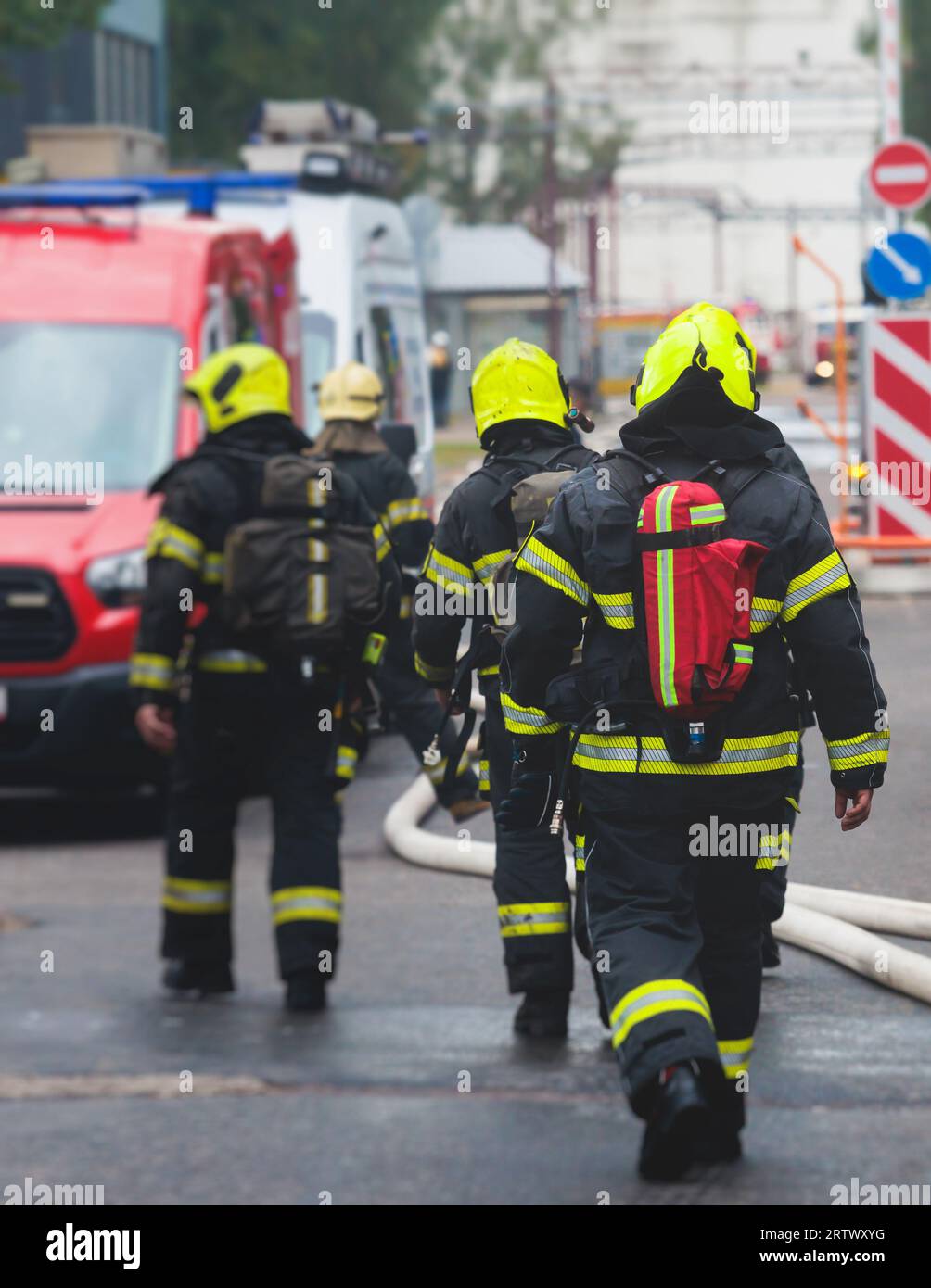 Group of fire men in protective uniform during fire fighting operation ...