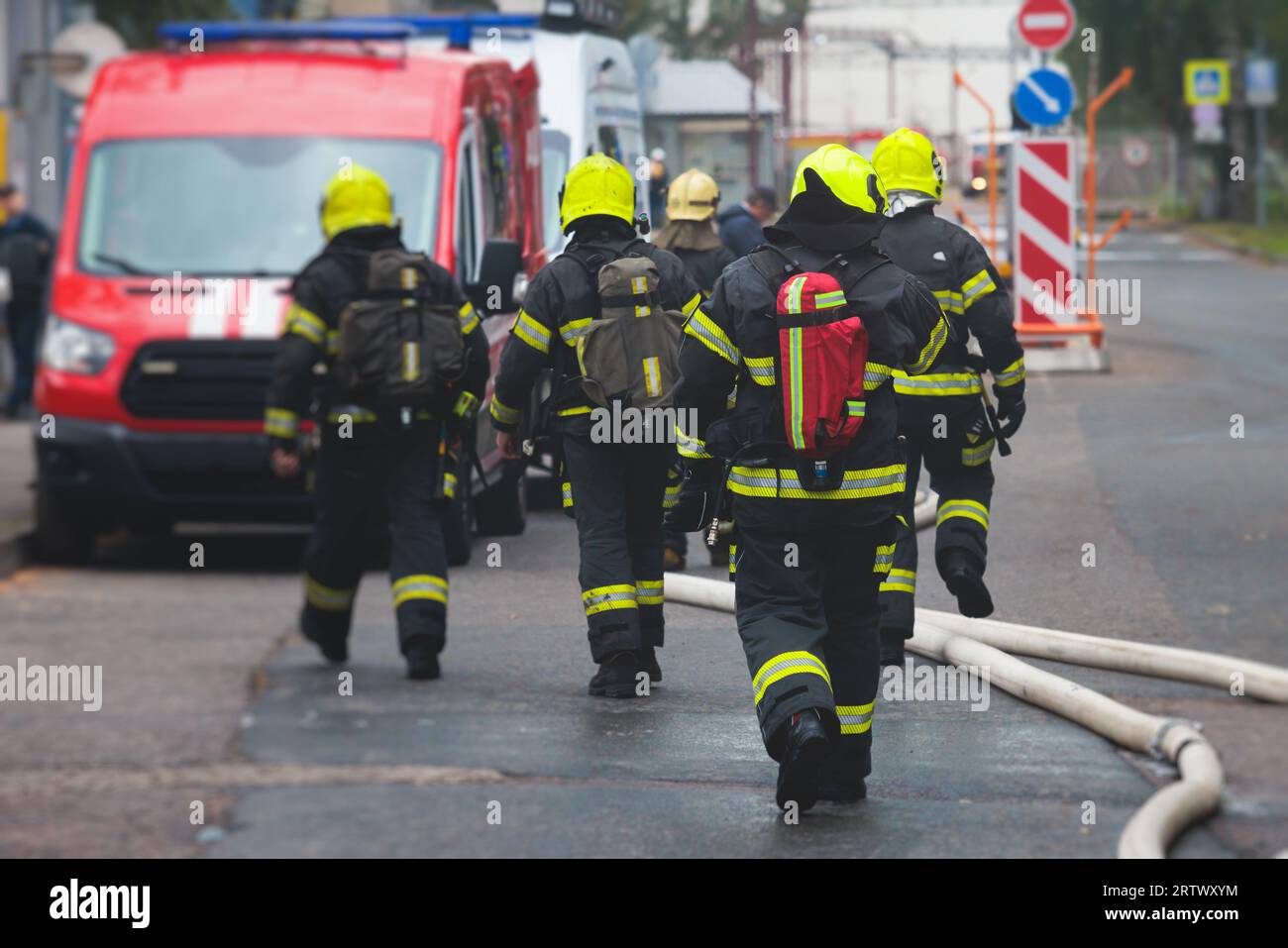 Group of fire men in protective uniform during fire fighting operation ...
