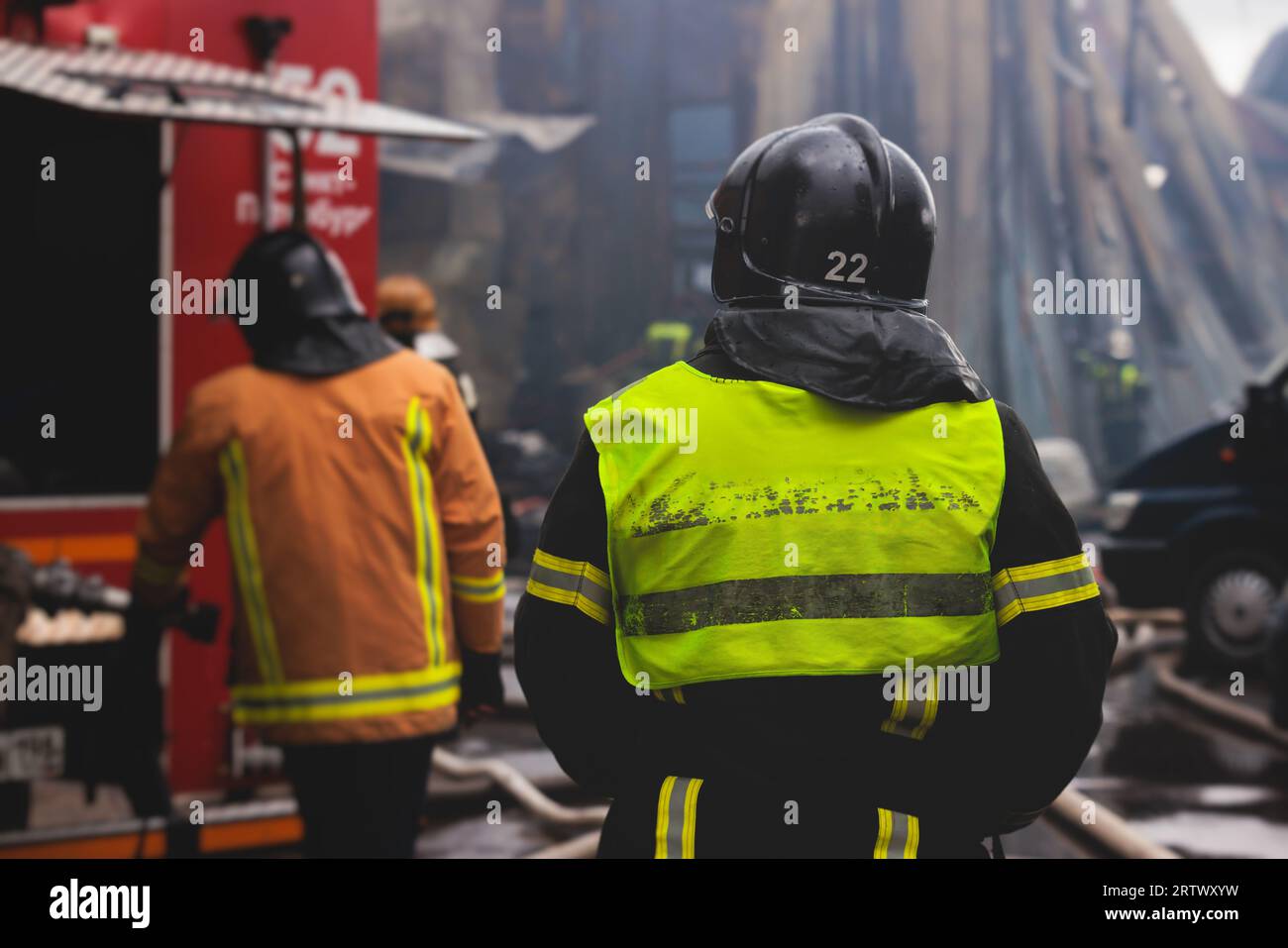 Group of fire men in protective uniform during fire fighting operation ...