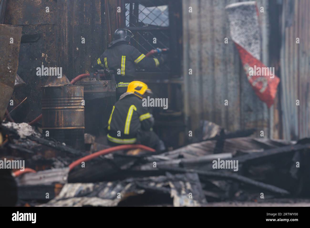 Group of fire men in protective uniform during fire fighting operation ...