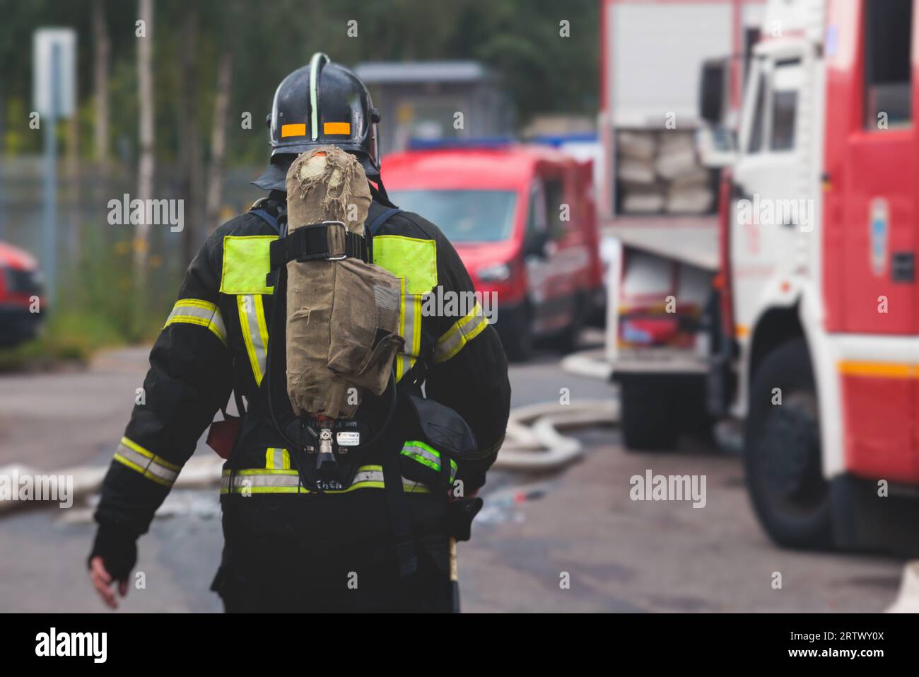 Group of fire men in protective uniform during fire fighting operation ...