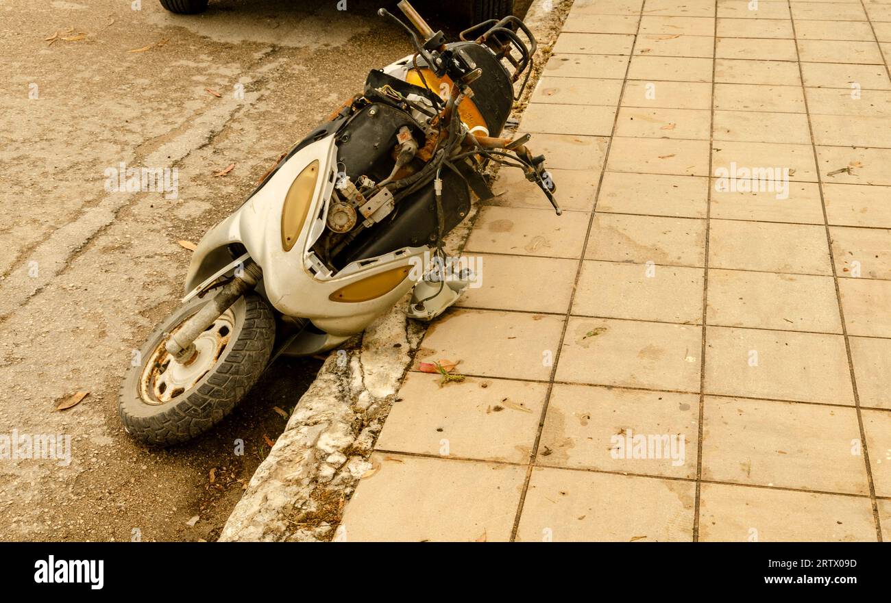 Old wrecked and rusted motorbike lying abandoned in the street in ...