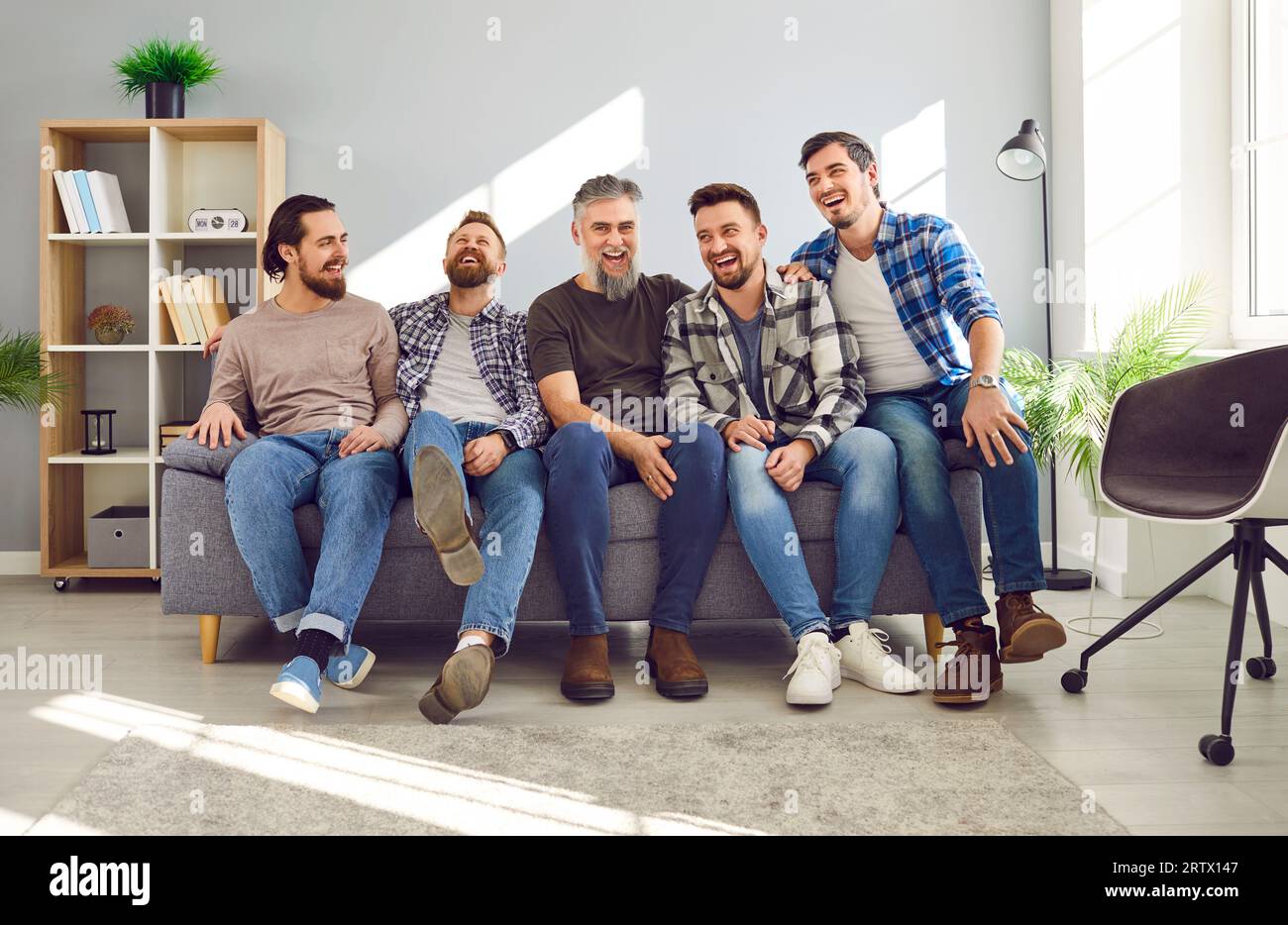 Happy, cheerful, smiling friends or father and adult sons sitting on ...