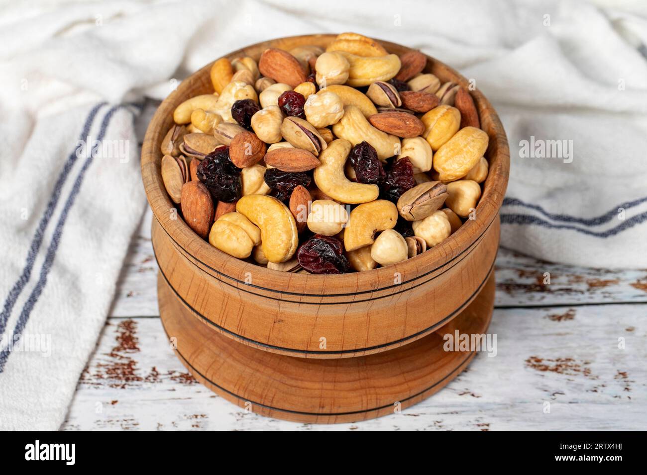 Mixed nuts in wood bowl. Nuts on white wood background. Mixed nuts ...