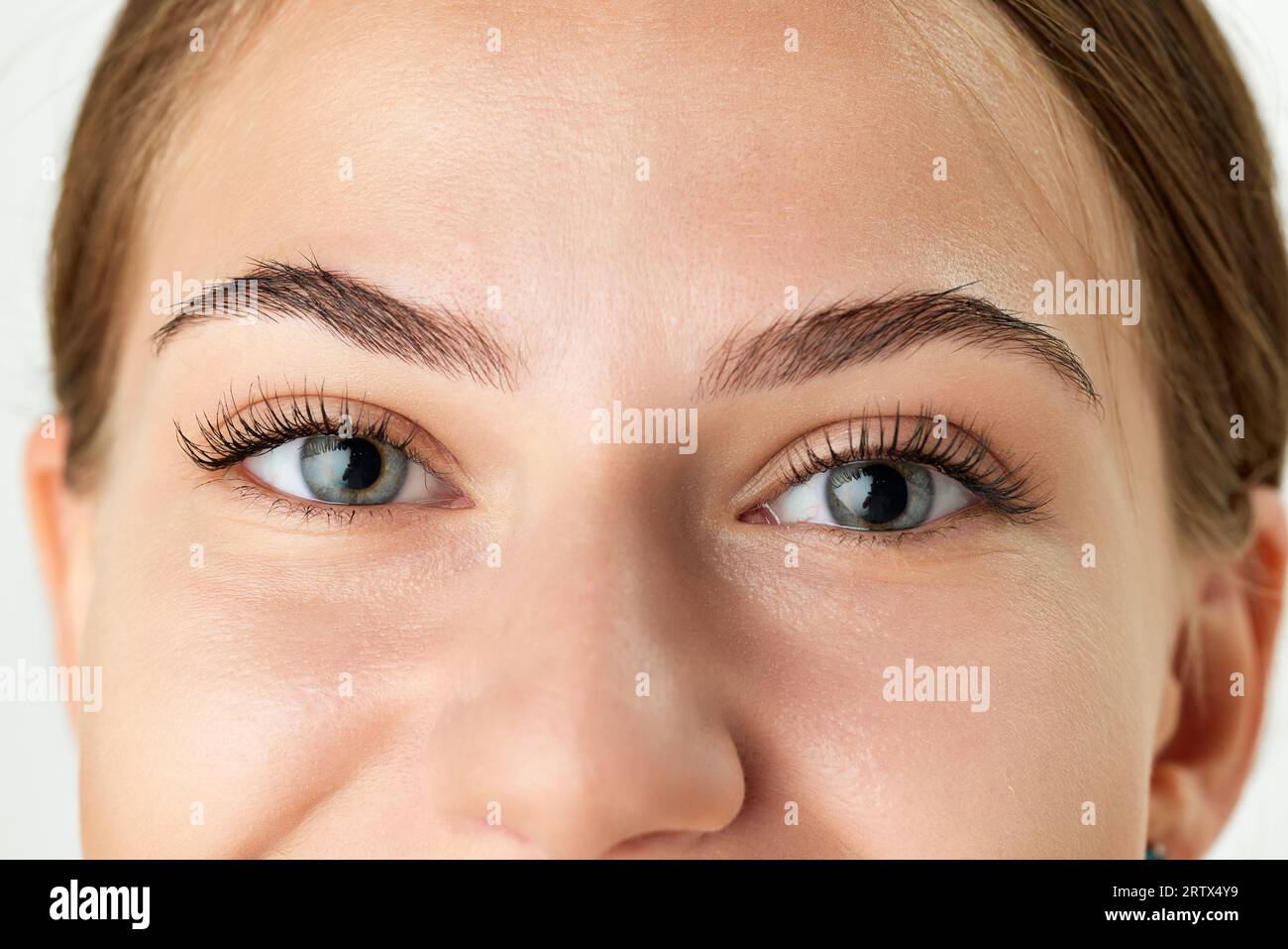Close-up of female face, brows, eyes and nose isolated on white ...