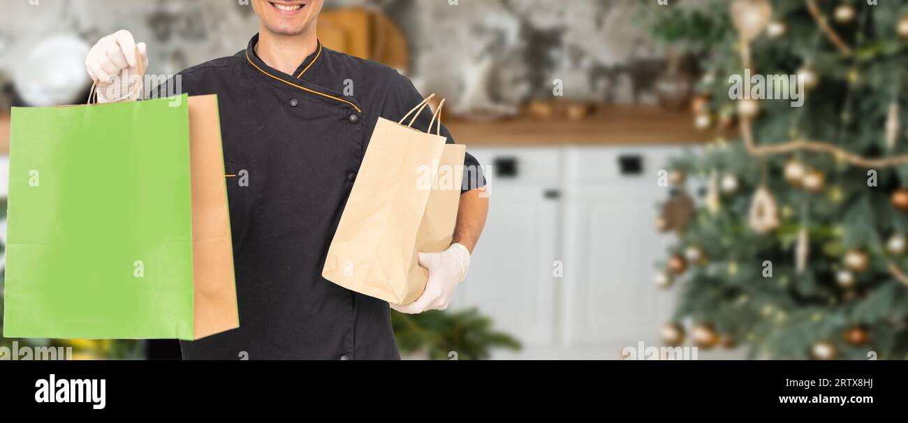 box with fast food being carried by delivery man in uniform for one of ...