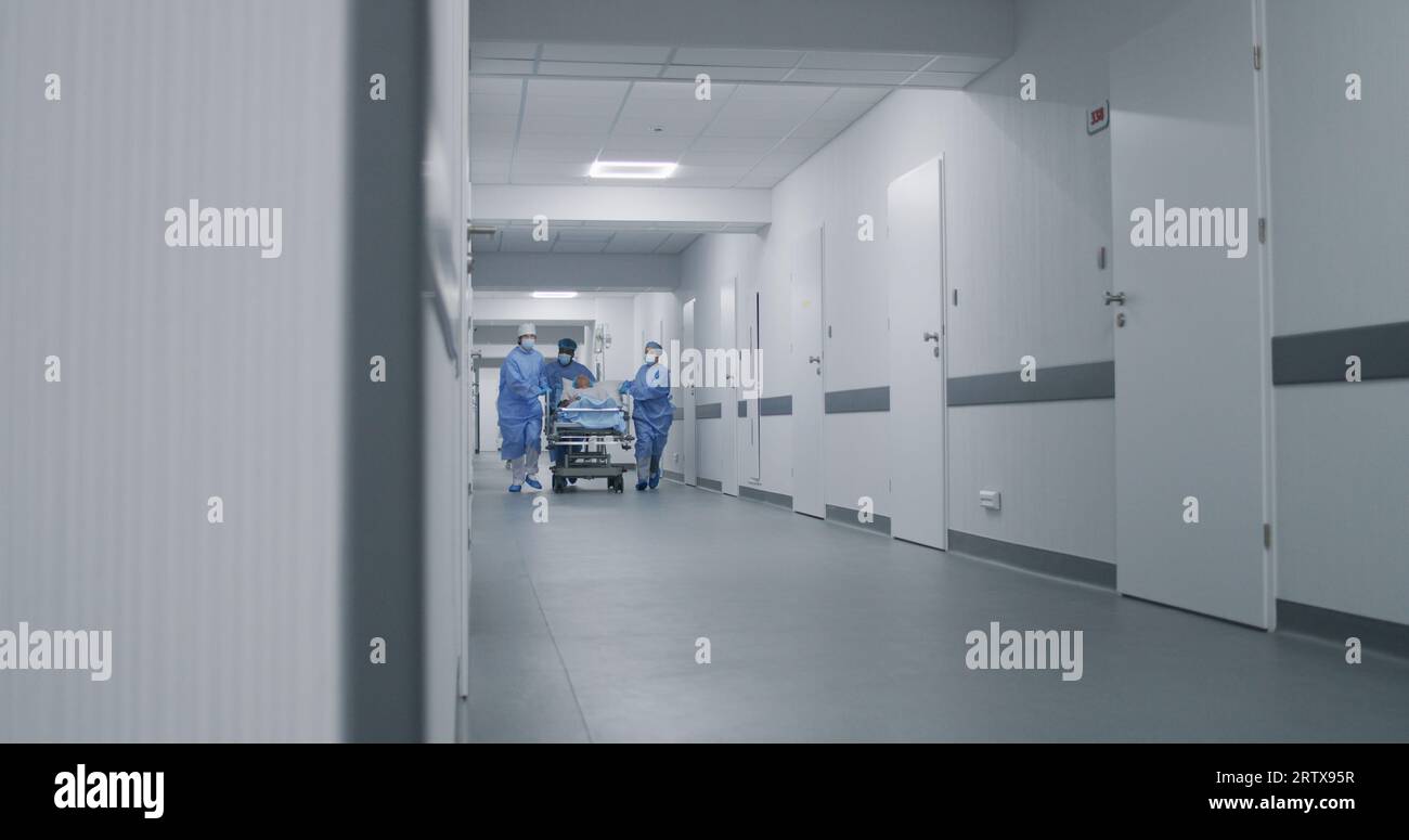 Doctors, nurses and paramedics run and push stretcher with seriously ...