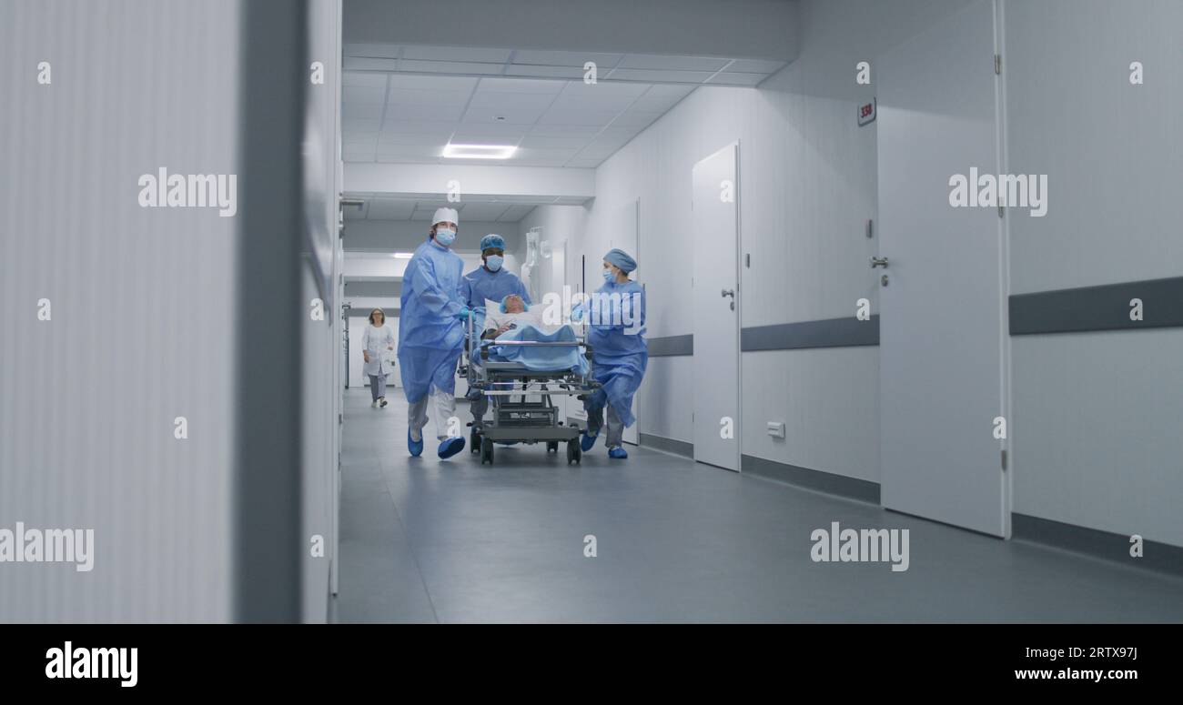 Doctors, nurses and paramedics run and push stretcher with seriously ...