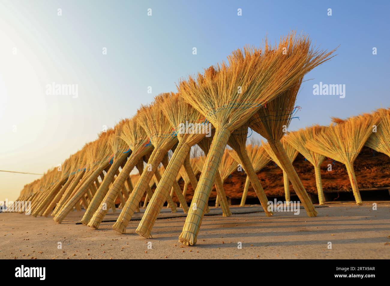 A large broom hanging on the roof is in a manual processing yard, North ...
