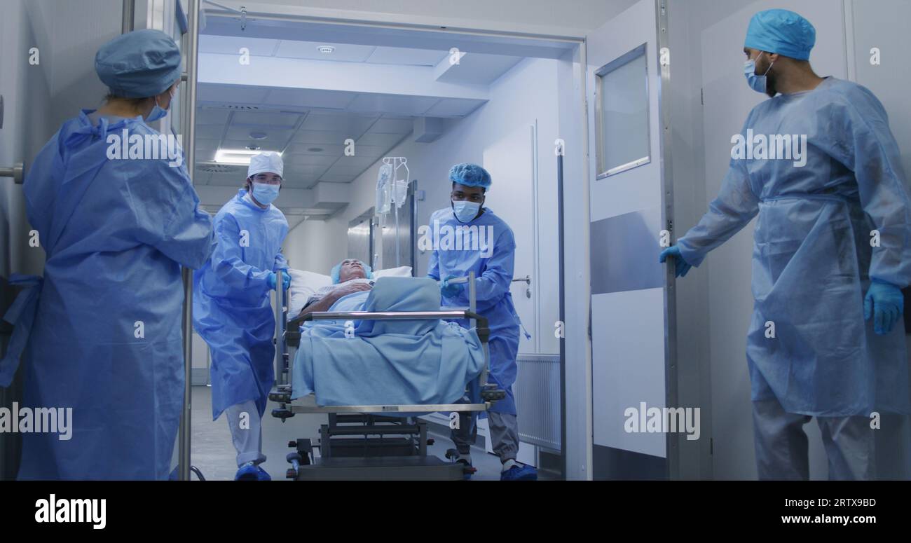 Nurse and paramedic open medical facility corridor doors. Multi ethnic ...