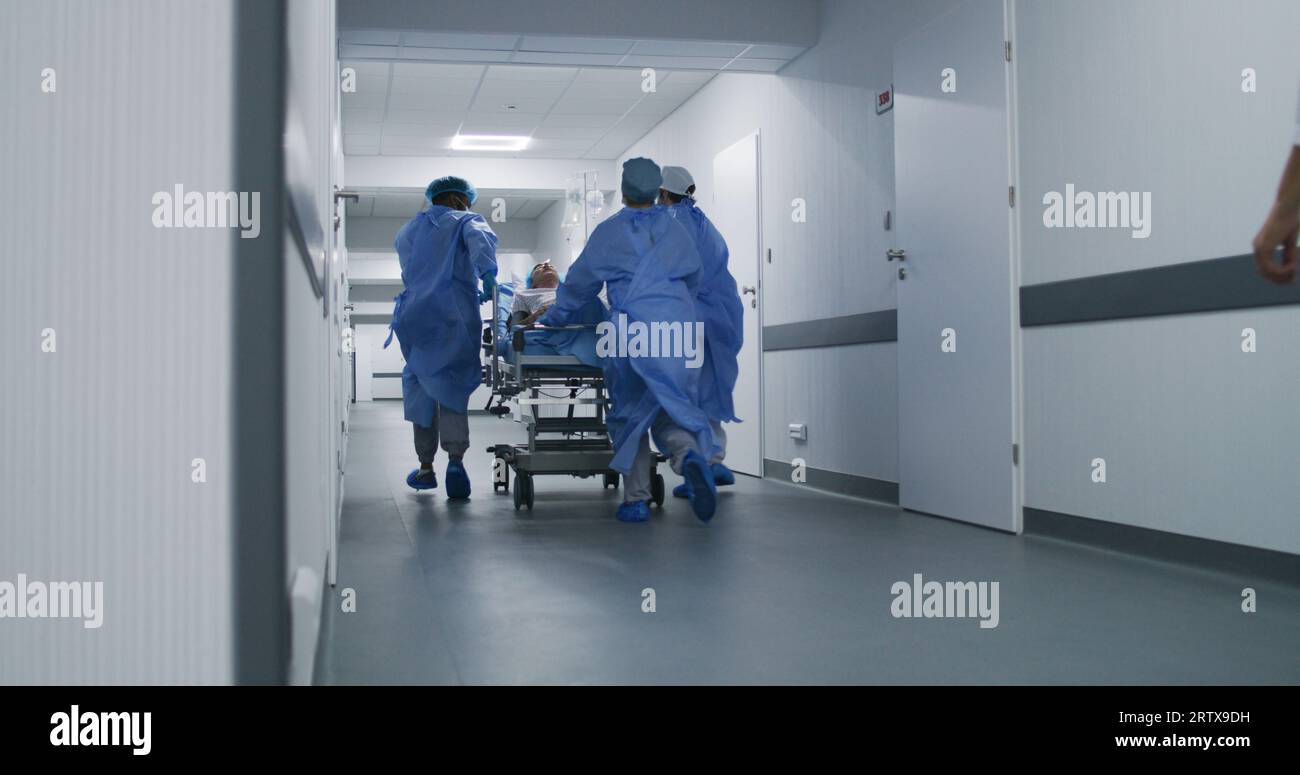 Doctors, nurses and paramedics run and push stretcher with seriously ...