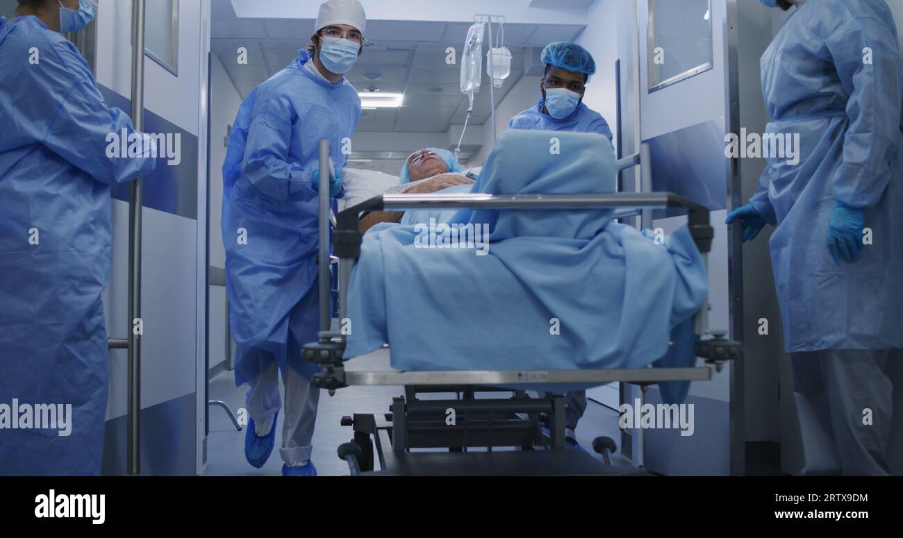 Nurse and paramedic open medical facility corridor doors. Multi ethnic ...