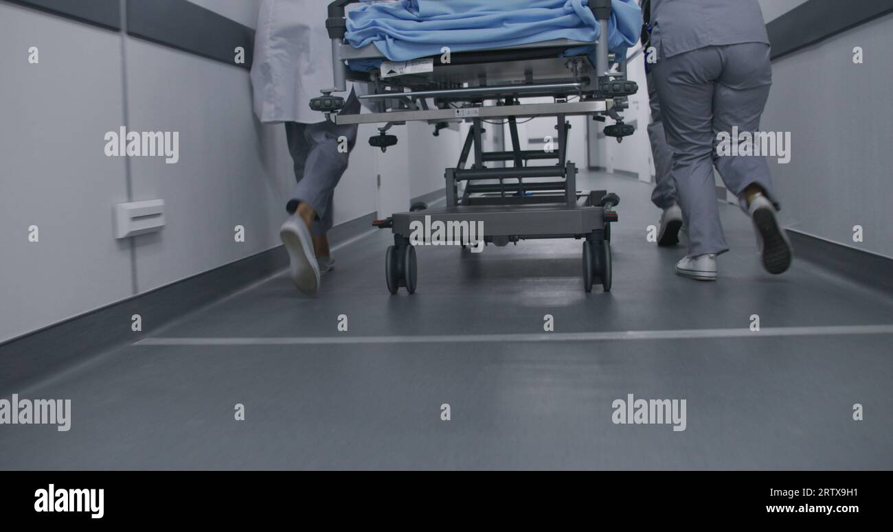 Doctors and nurses run and push stretcher with seriously injured ...