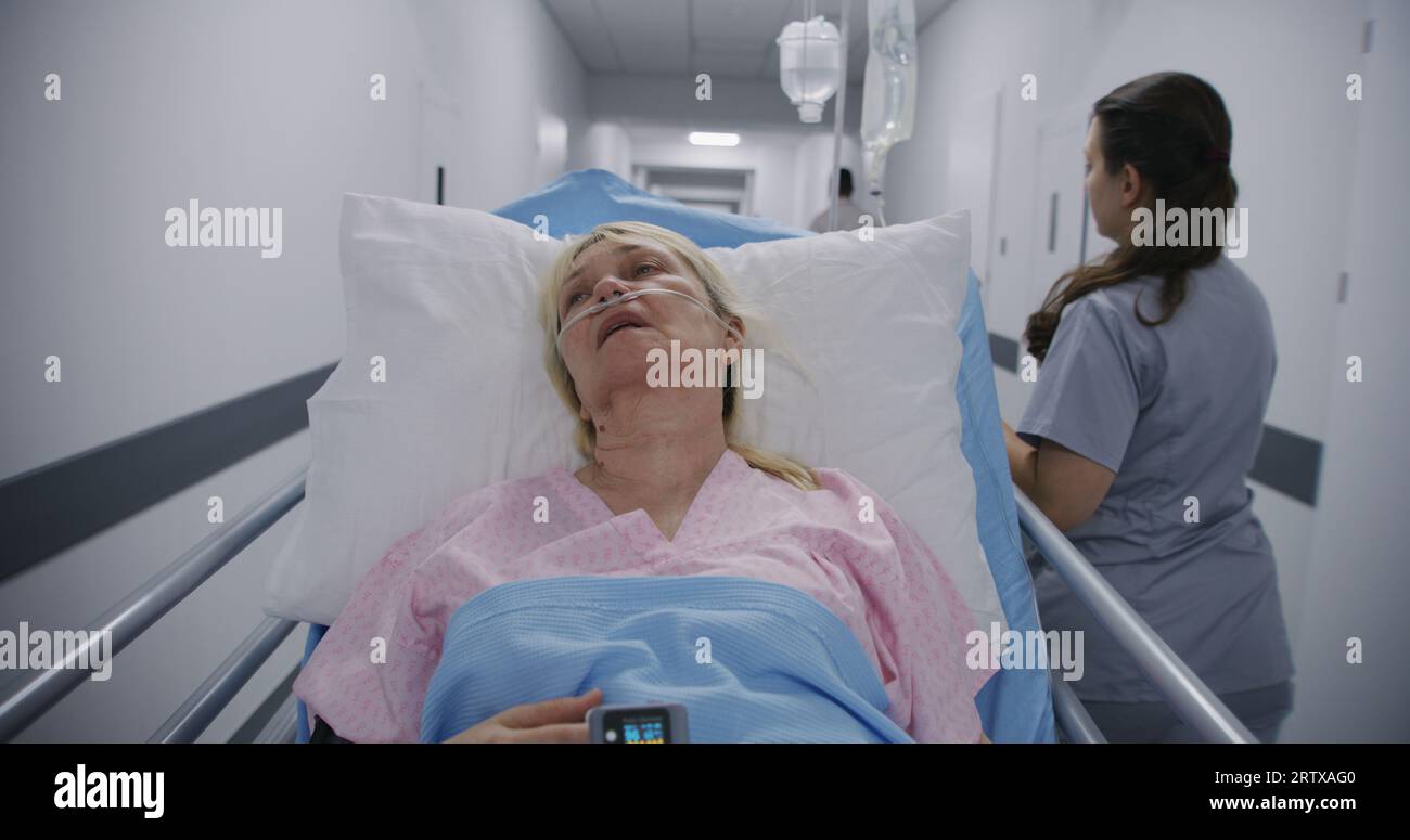 Young nurse transports elderly woman hi-res stock photography and ...