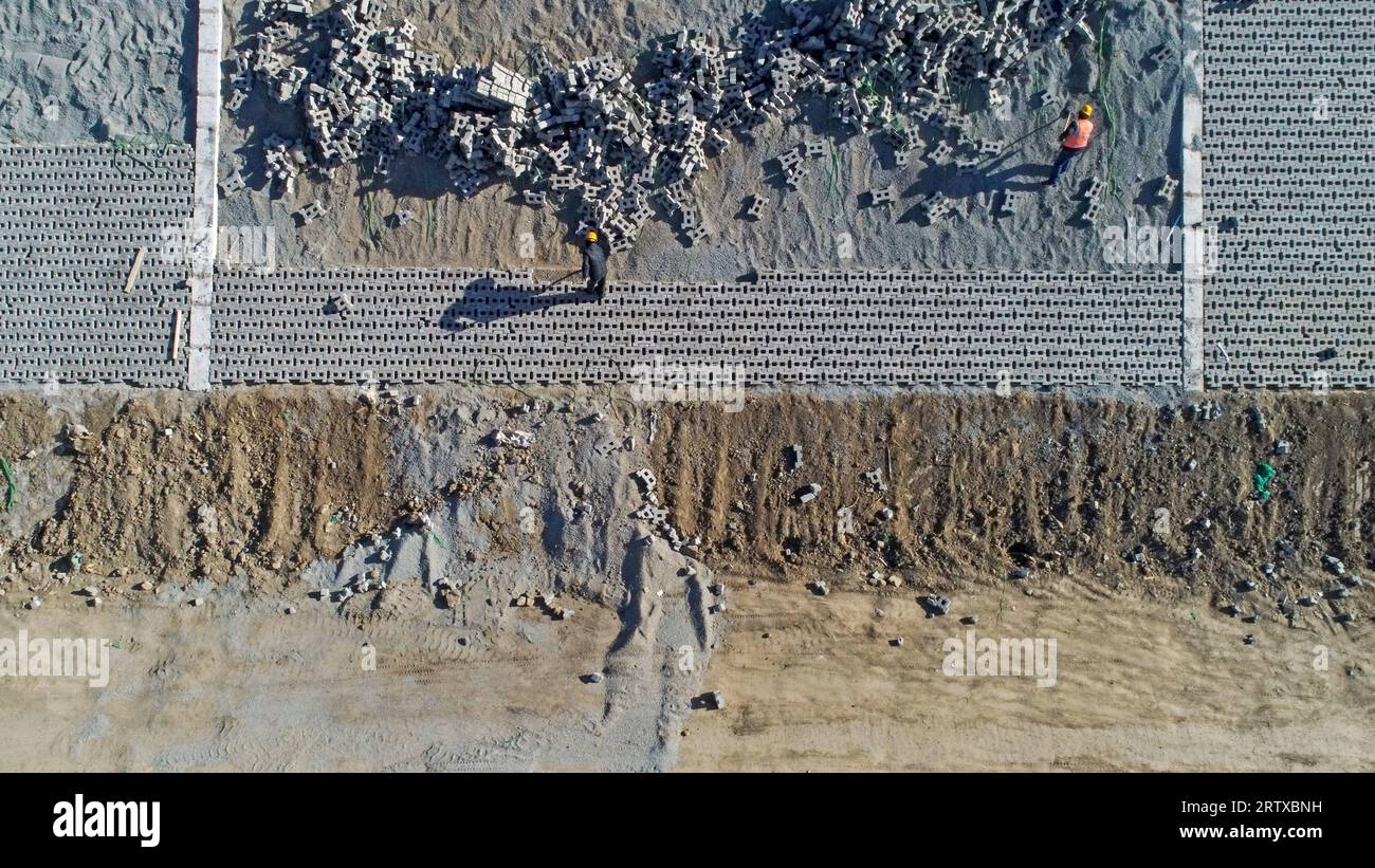 Workers are building river slope protection at a water conservancy ...