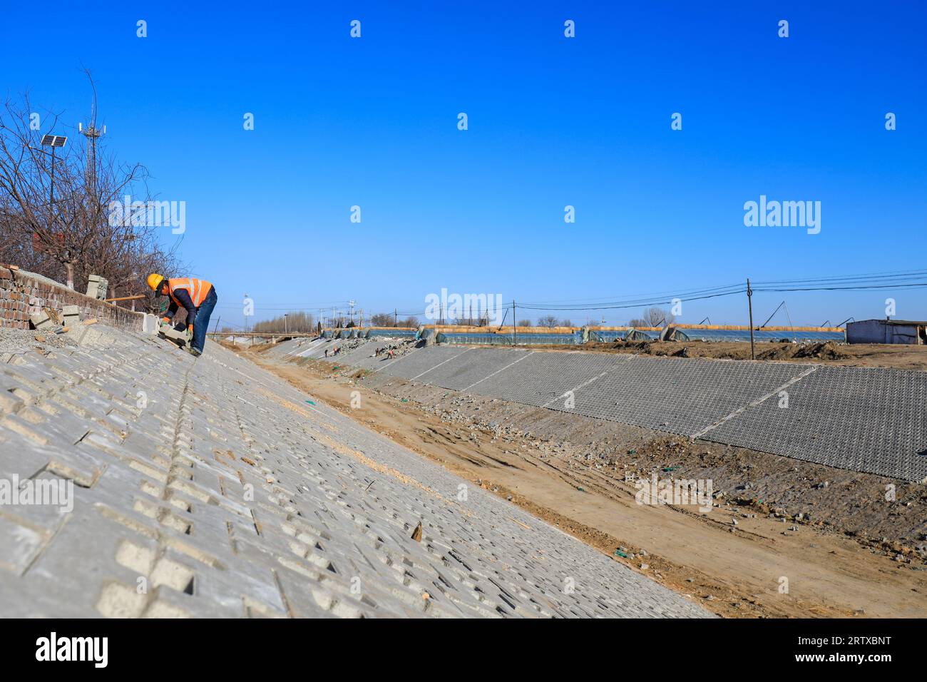 Tangshan, China - December 24, 2021:Workers are building river slope ...