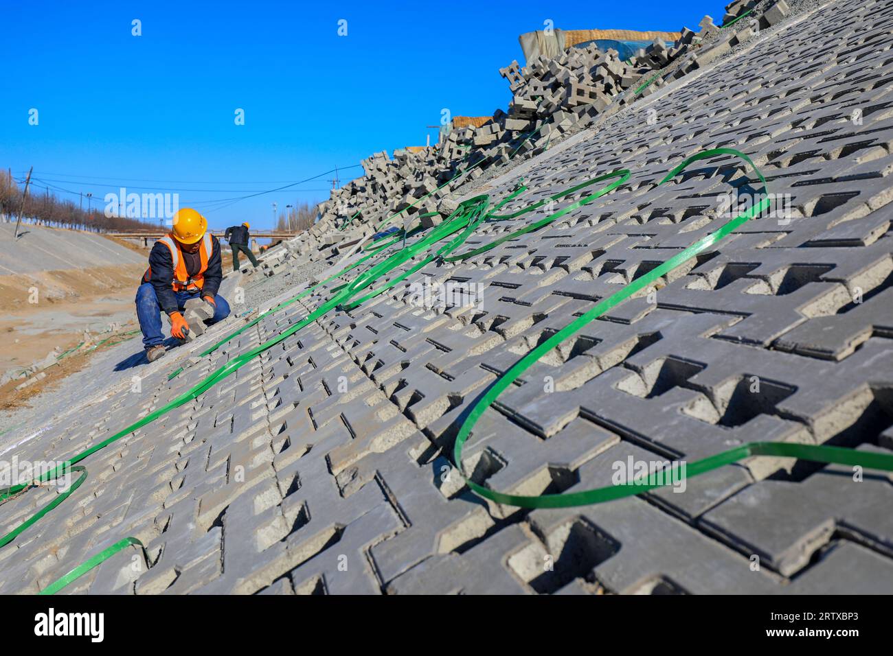 Tangshan, China - December 24, 2021:Workers are building river slope ...