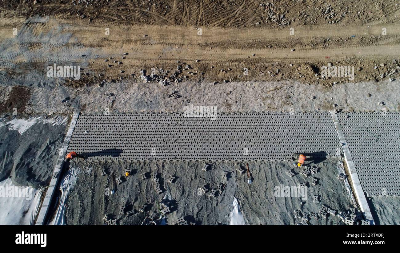 Workers are building river slope protection at a water conservancy ...