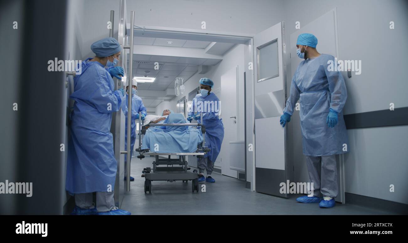 Multi ethnic surgeons push stretcher hi-res stock photography and ...